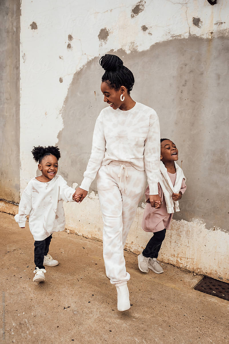 "Stylish Family Walking On Sidewalk" by Stocksy Contributor "Sweenshots ...