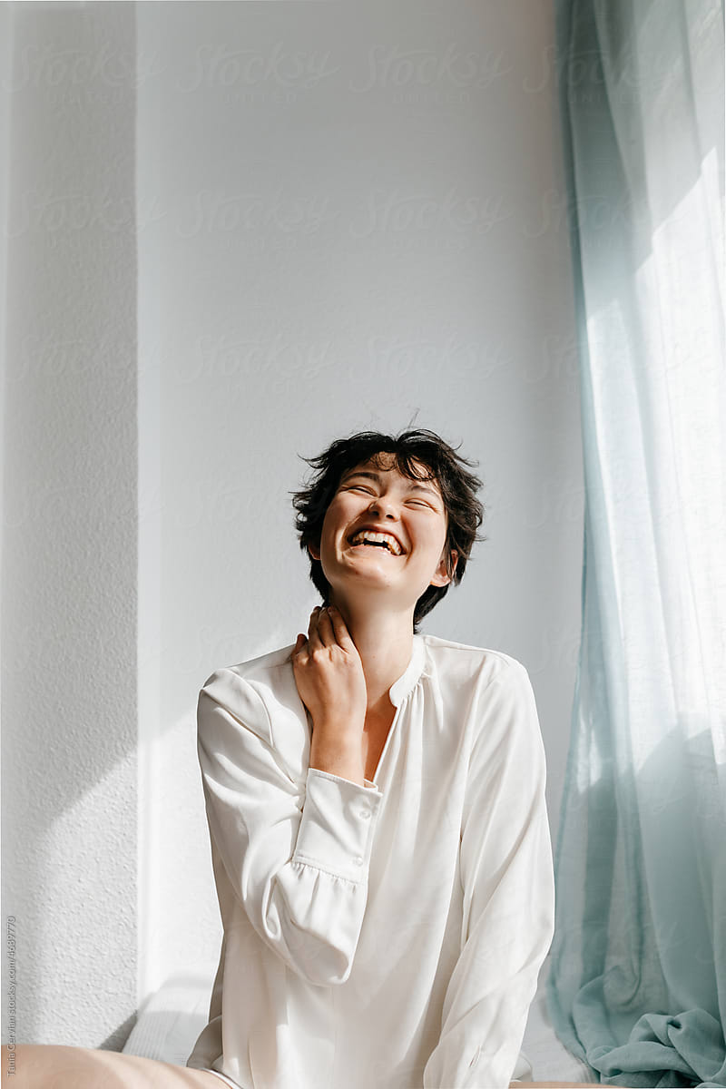 "Cheerful Young Androgynous Person Laughing With Closed Eyes" by ...