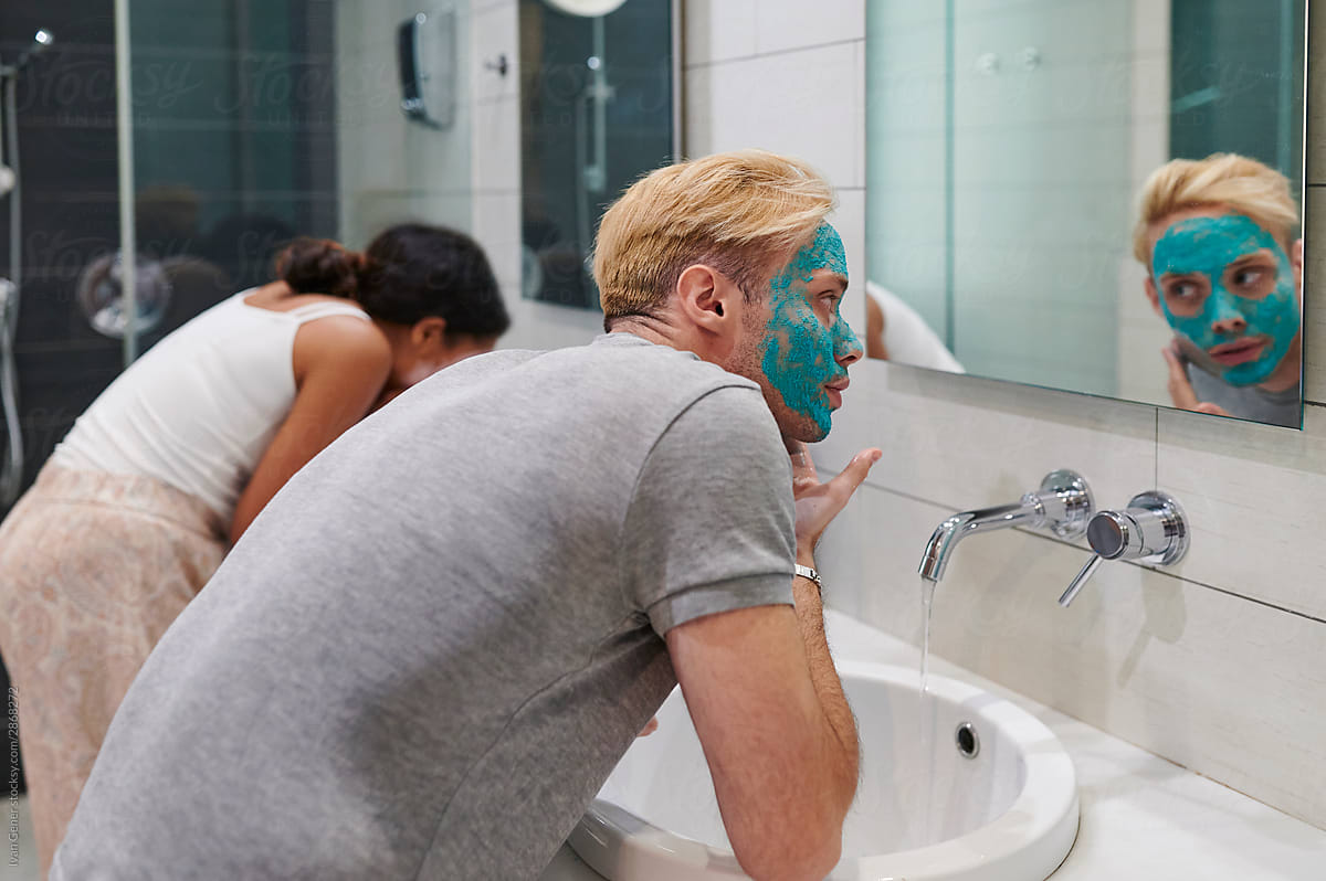 "Couple Washing Off Face Masks" by Stocksy Contributor "Ivan Gener ...