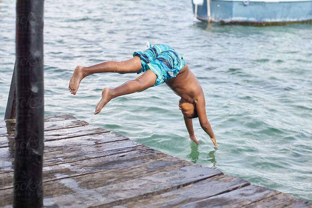 "Boy Plunging Into The Ocean" by Stocksy Contributor "PER Images" - Stocksy