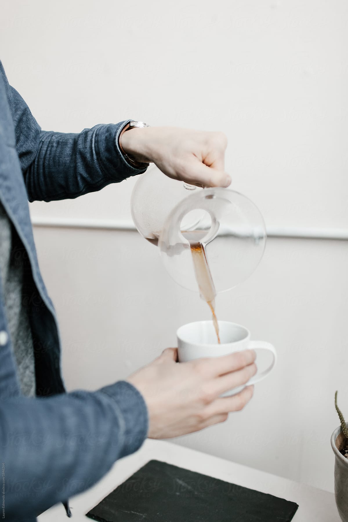 "Man Pouring Coffee Into White Mug" by Stocksy Contributor "Lauren ...
