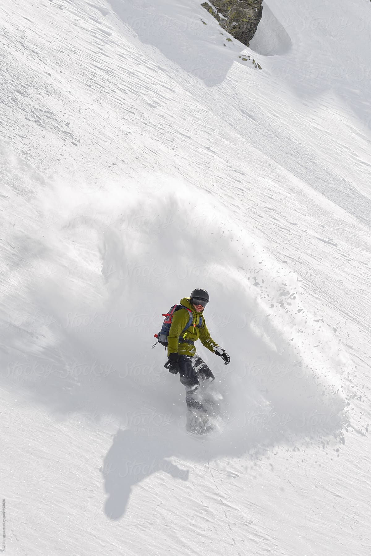 Snowboarder riding downhill with speed - Stock Image - Everypixel