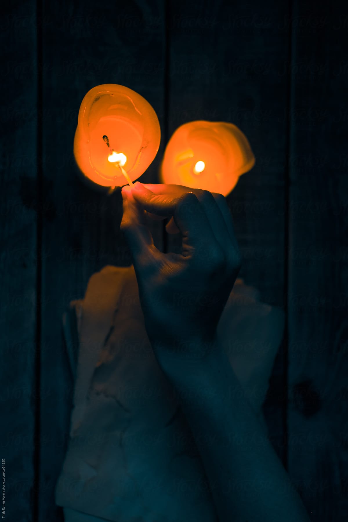 woman lights a match to light a candle - Stock Image - Everypixel