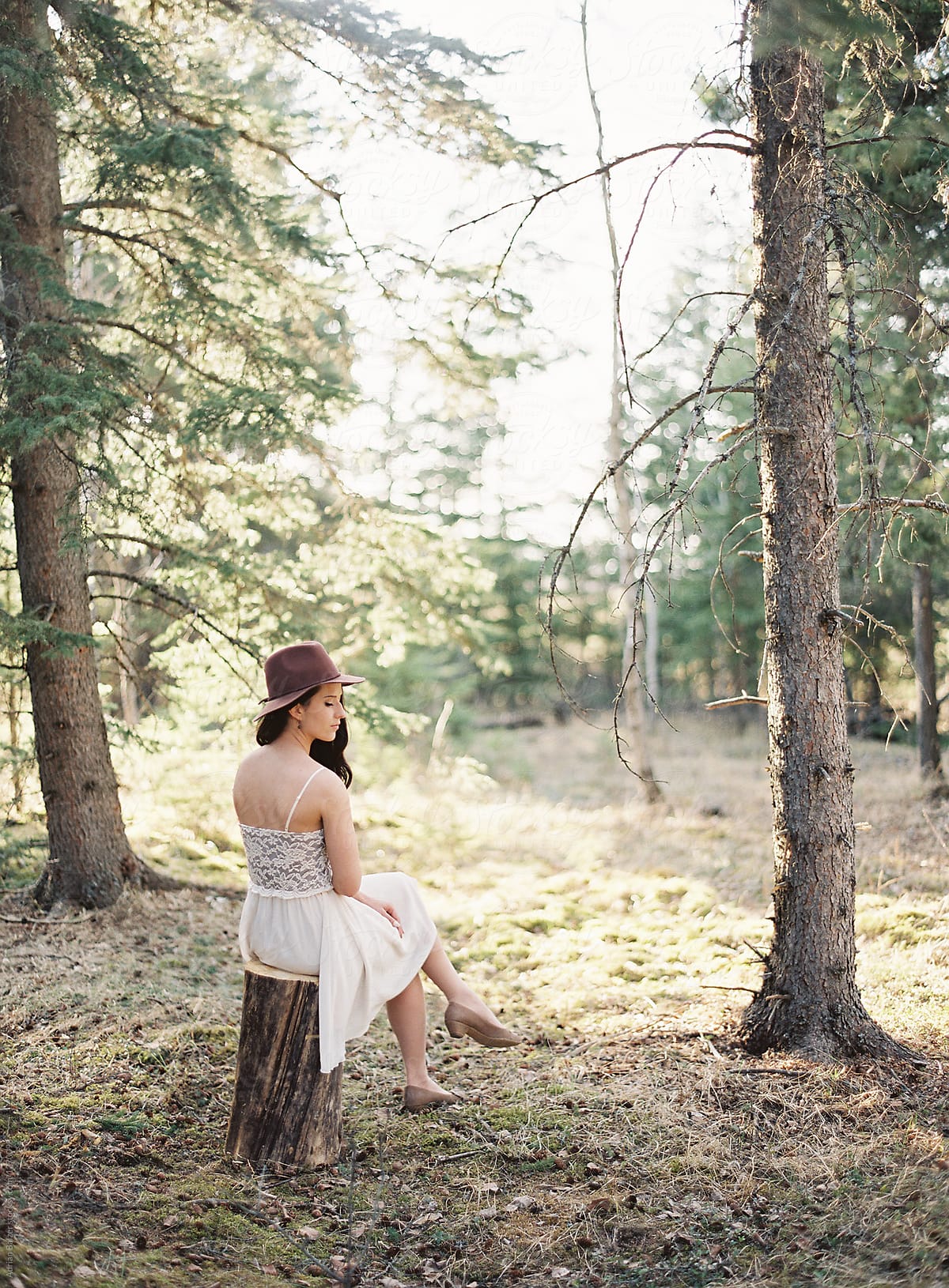"Girl On Tree Stump" by Stocksy Contributor "Adrian Balzer" - Stocksy
