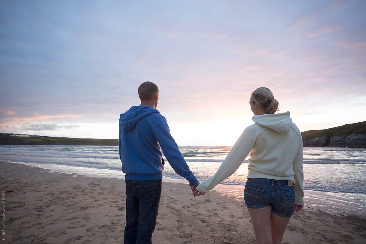 "Couple On Beach At Sunset." by Stocksy Contributor "Hugh Sitton" - Stocksy