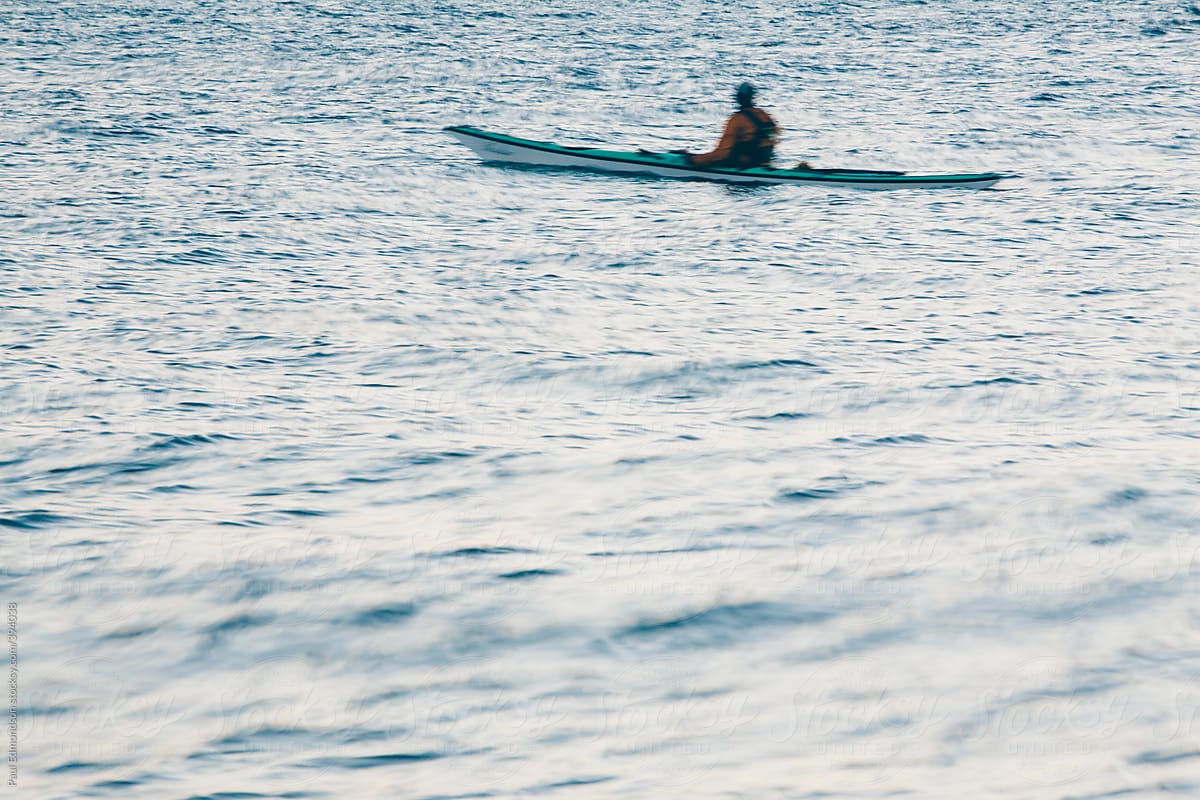 "Man Sea Kayaking At Dusk" by Stocksy Contributor "Rialto Images" - Stocksy