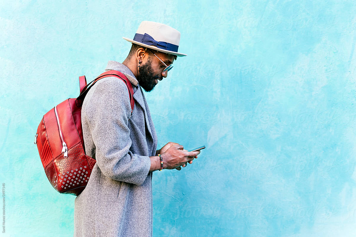 "African Man Using Mobile Phone" by Stocksy Contributor "Santi Nuñez ...