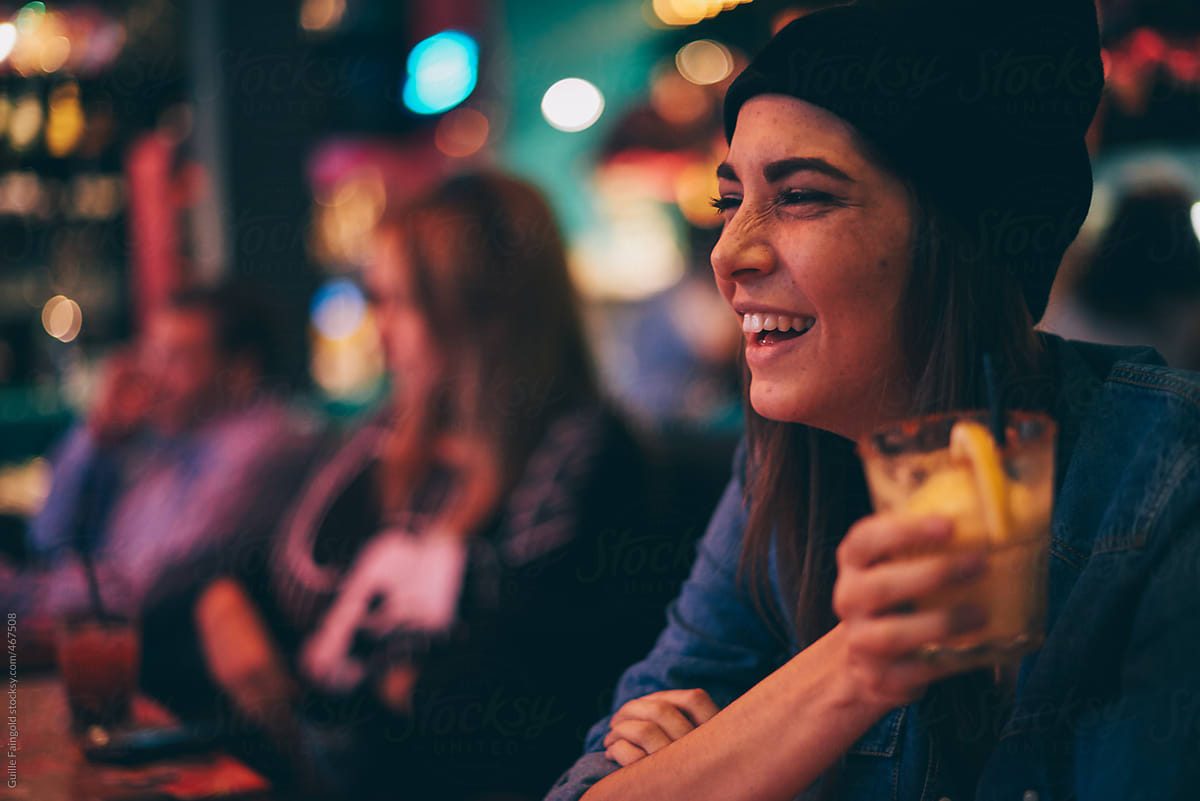 "Happy Girl In Pub" by Stocksy Contributor "Guille Faingold" - Stocksy