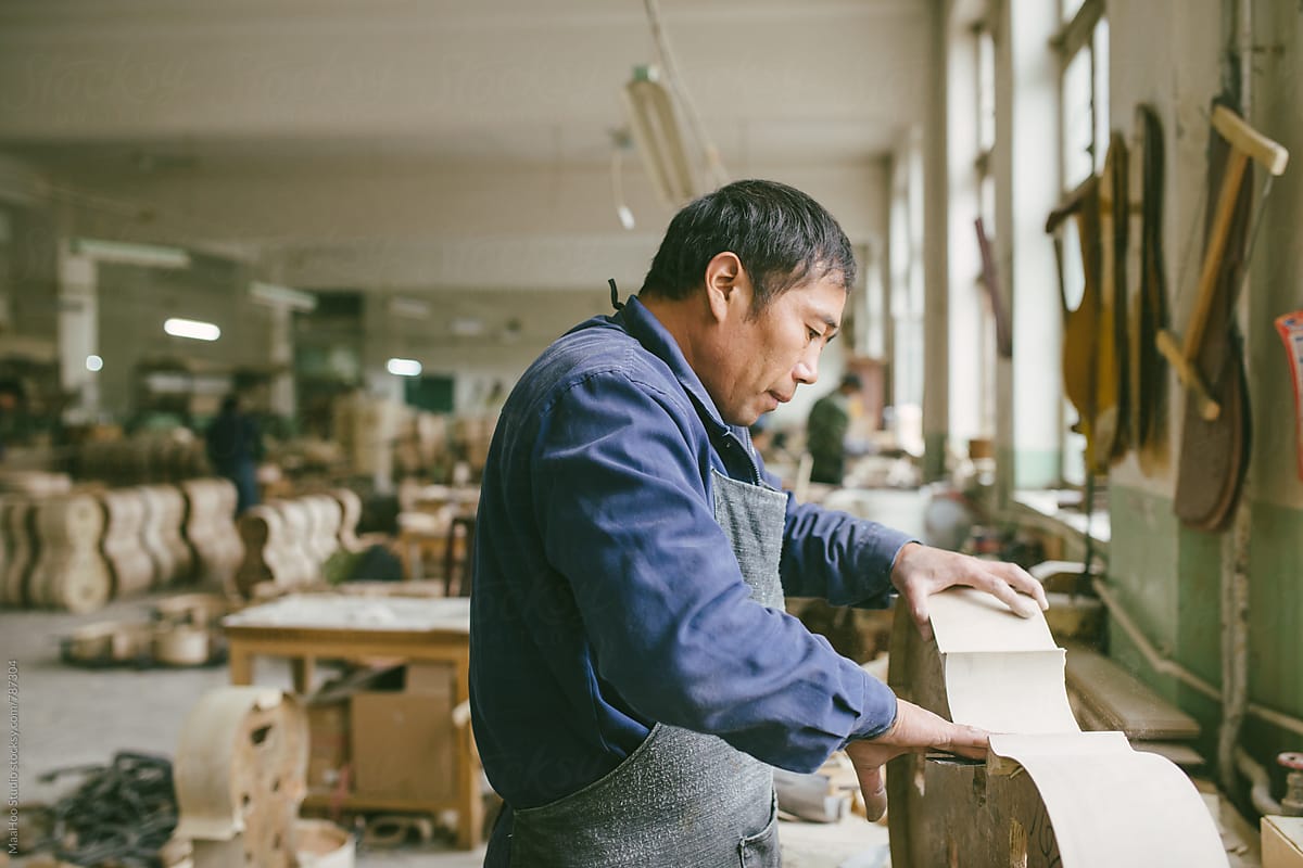 "Violoncello Maker At Work" by Stocksy Contributor "MaaHoo" - Stocksy