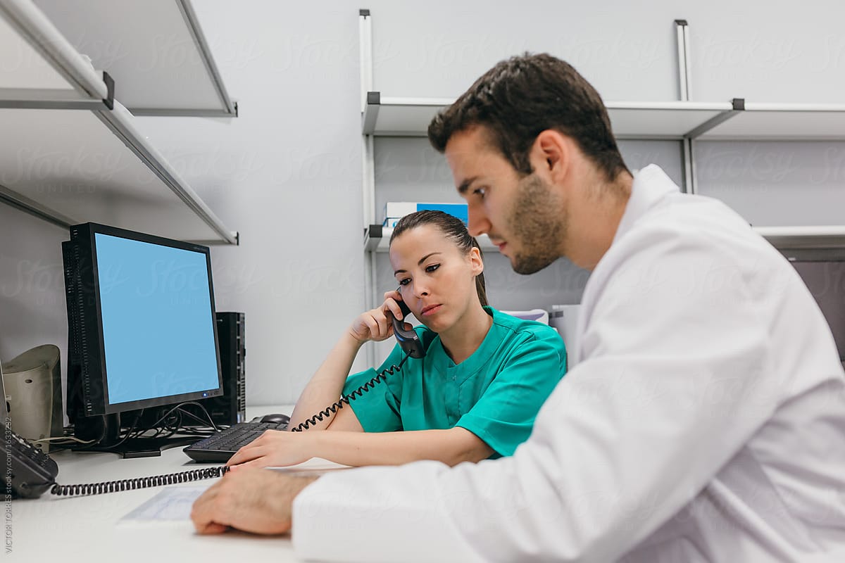 "Medics Working And Talking Phone" by Stocksy Contributor "VICTOR ...