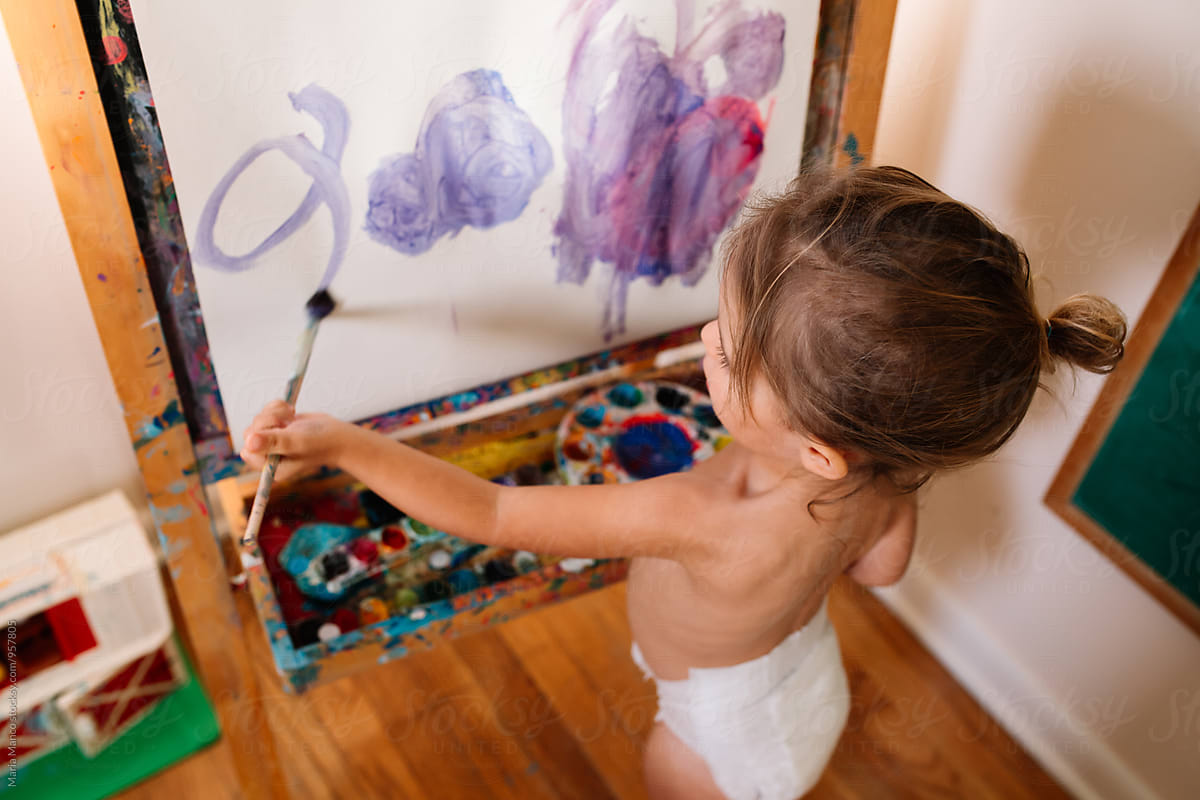 "Little Girl Painting At Easel In Diaper" by Stocksy Contributor "Maria ...