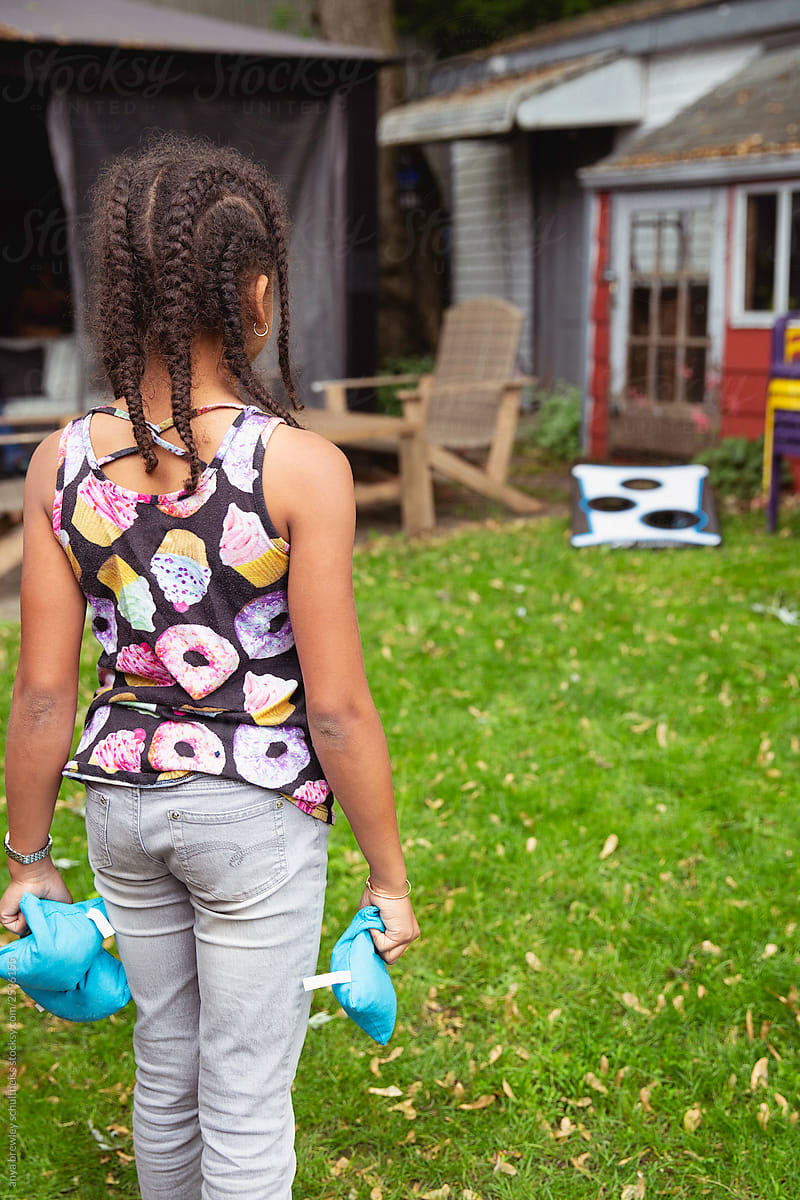 "Girl Preparing To Throw Bean Bags At A Corn Hole Board" by Stocksy ...