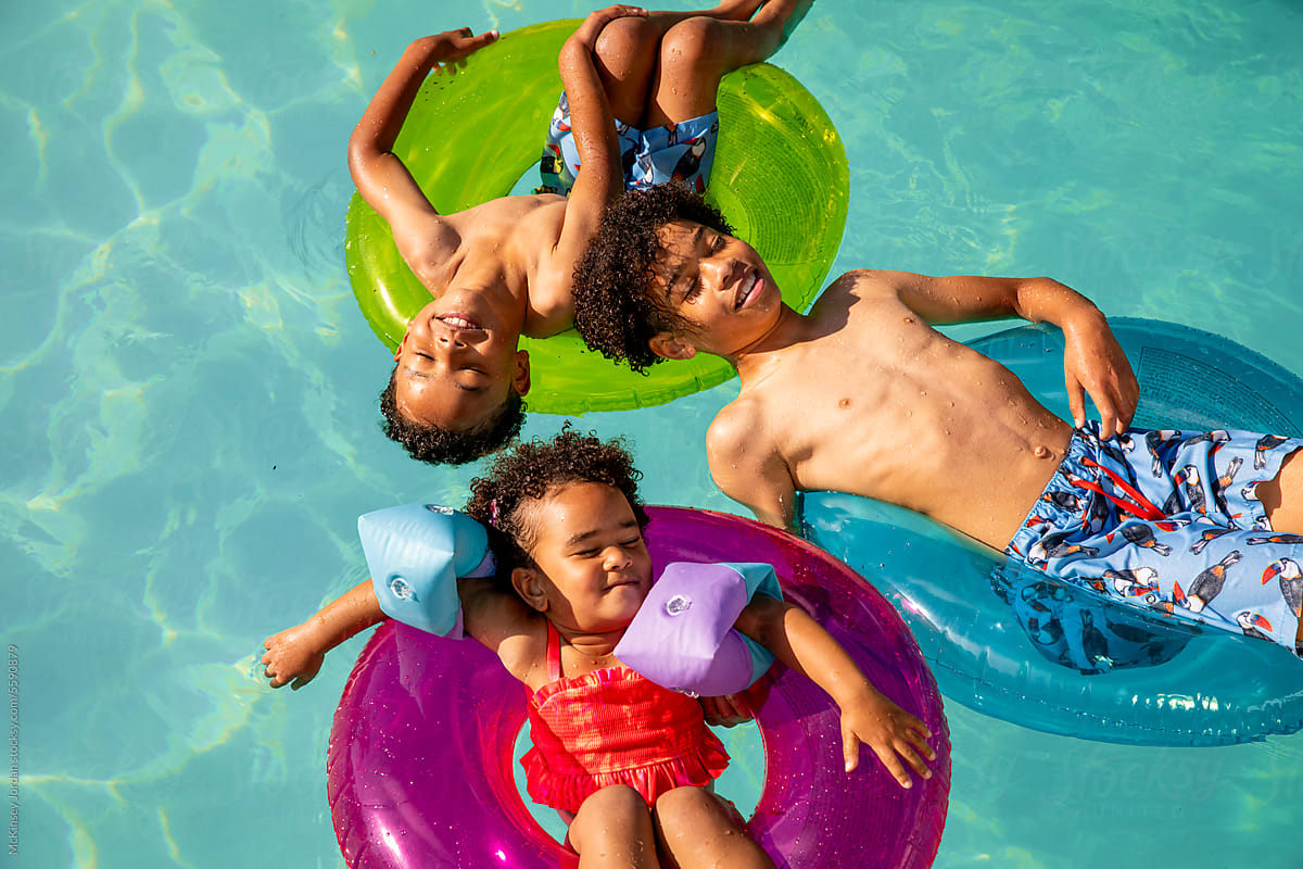 "Three Children Float In Pool During Summer" by Stocksy Contributor ...