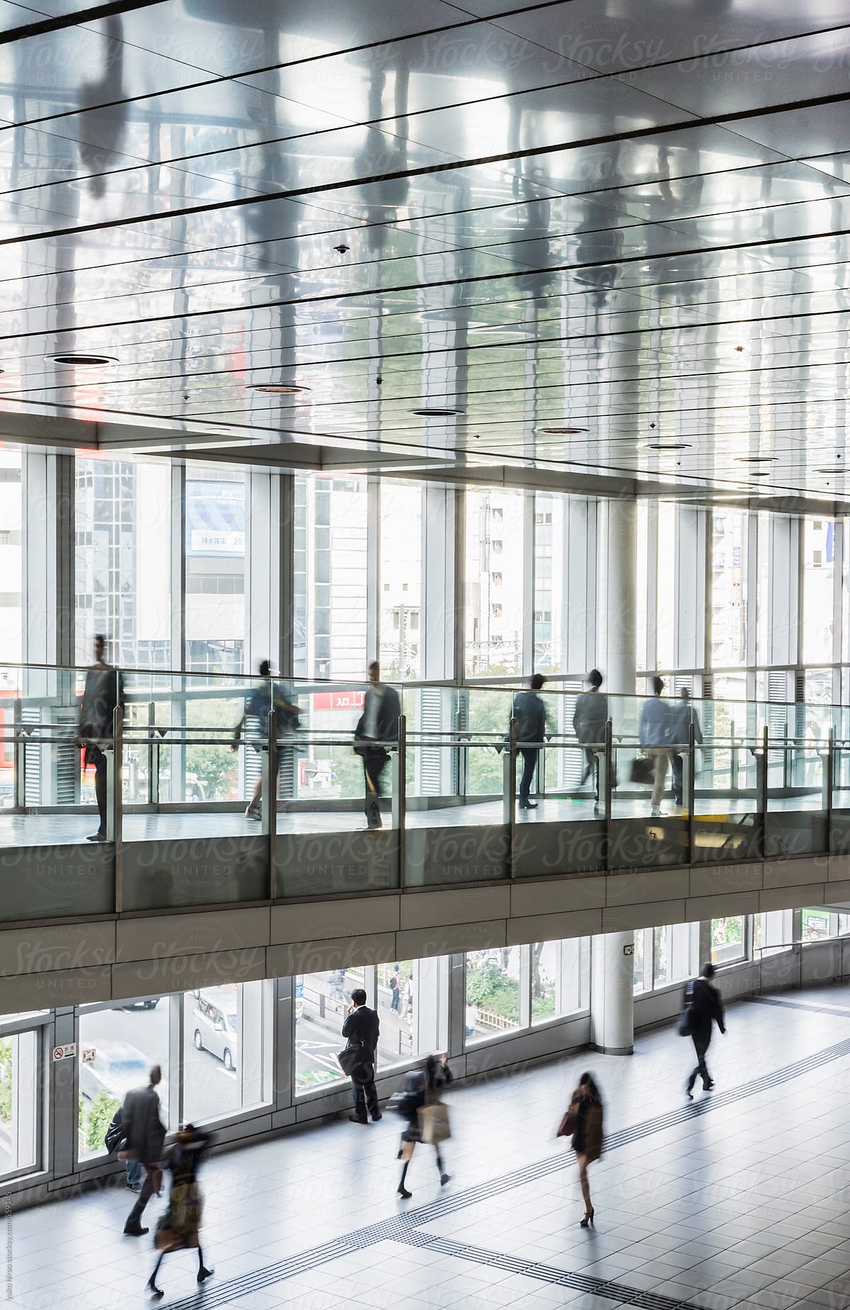 "Crowd Of People In A Modern Building" by Stocksy Contributor "Yuko ...