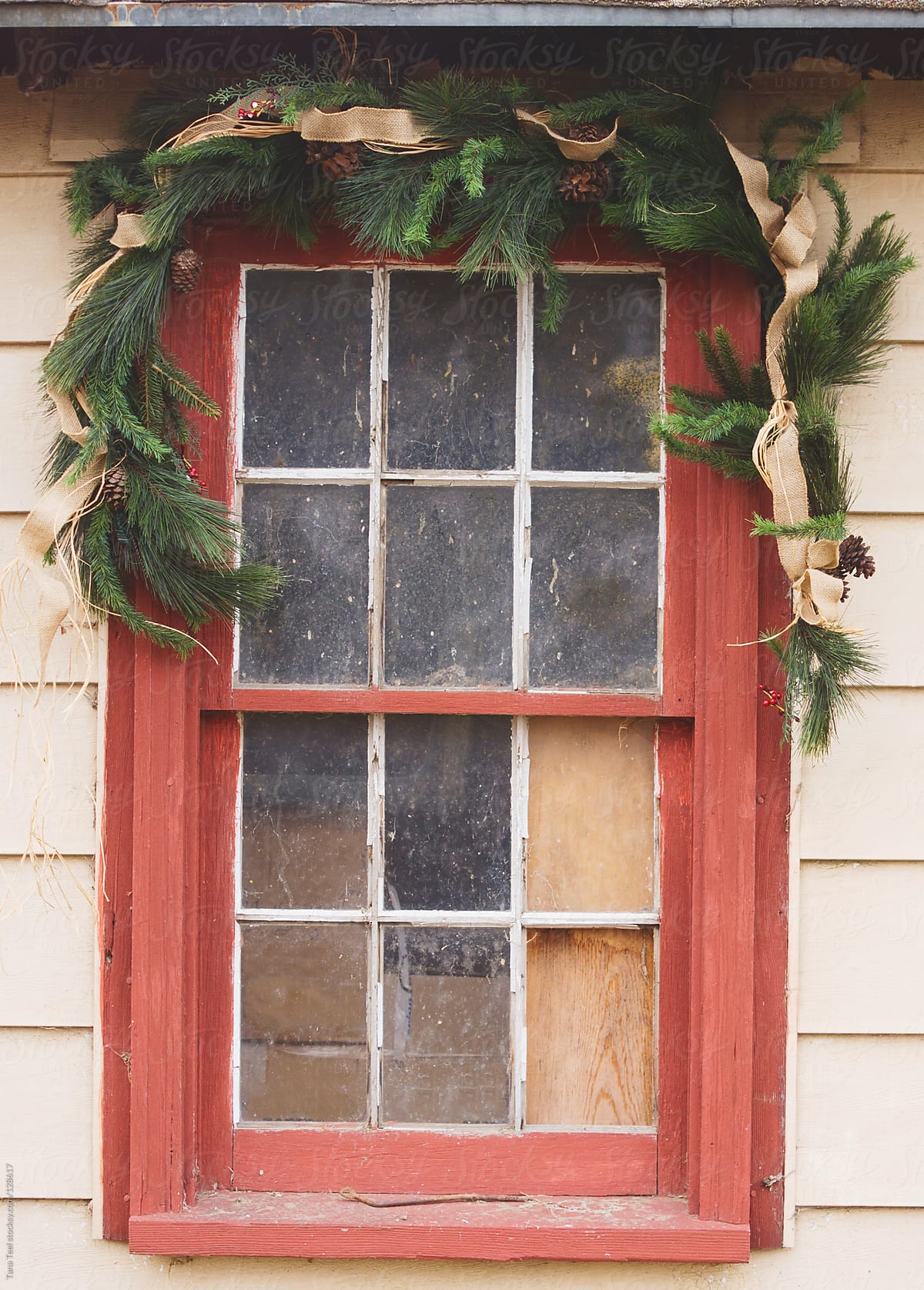 "An Old Window In A Shed Decorated With Evergreen Swag For The Holiday ...
