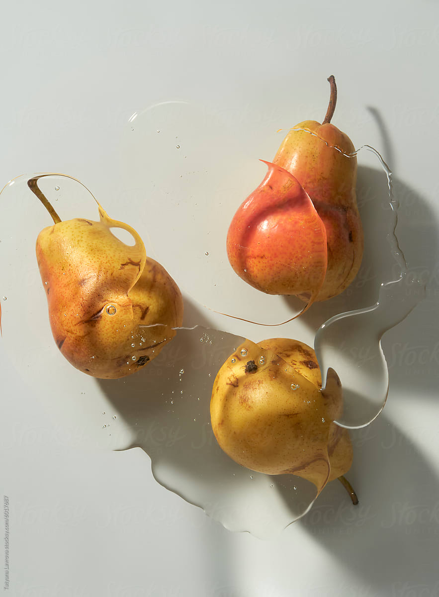 "Three Glistening Pears Under Glass On A Light Sunny Surface." by ...