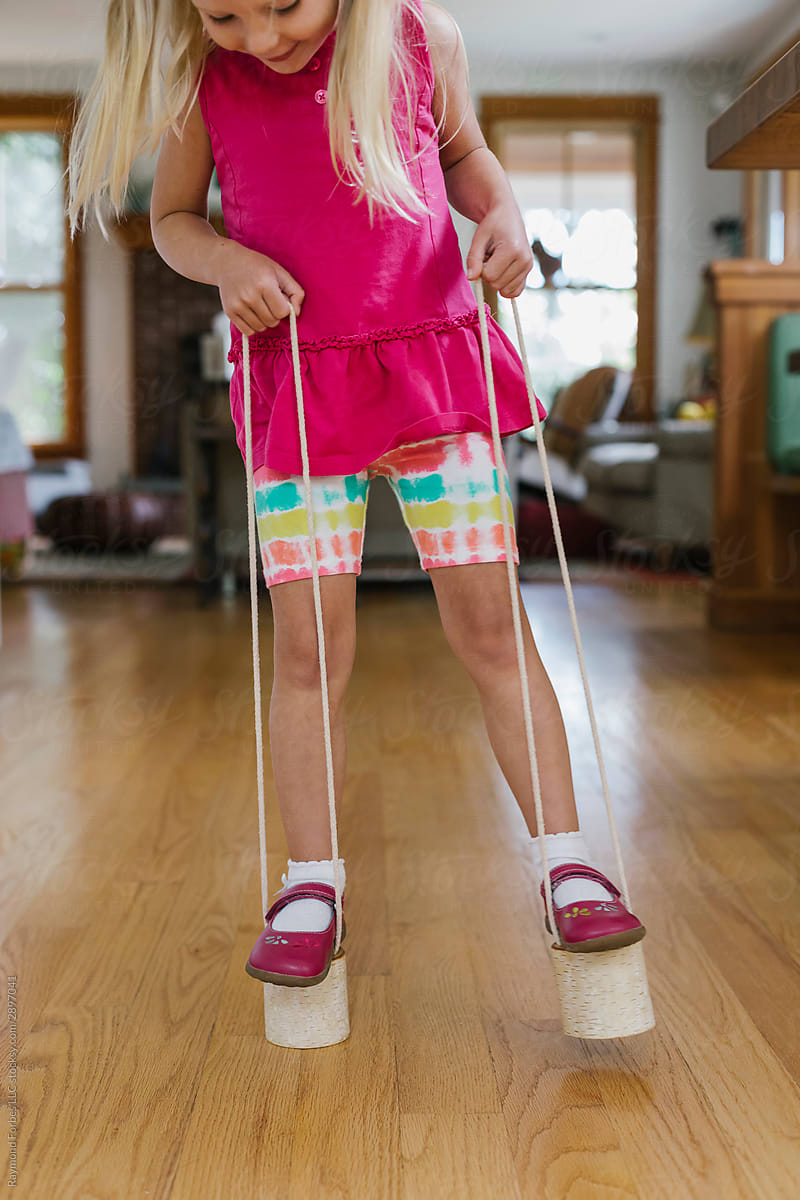 "Child Walking With Walking Stilts" by Stocksy Contributor "Raymond ...