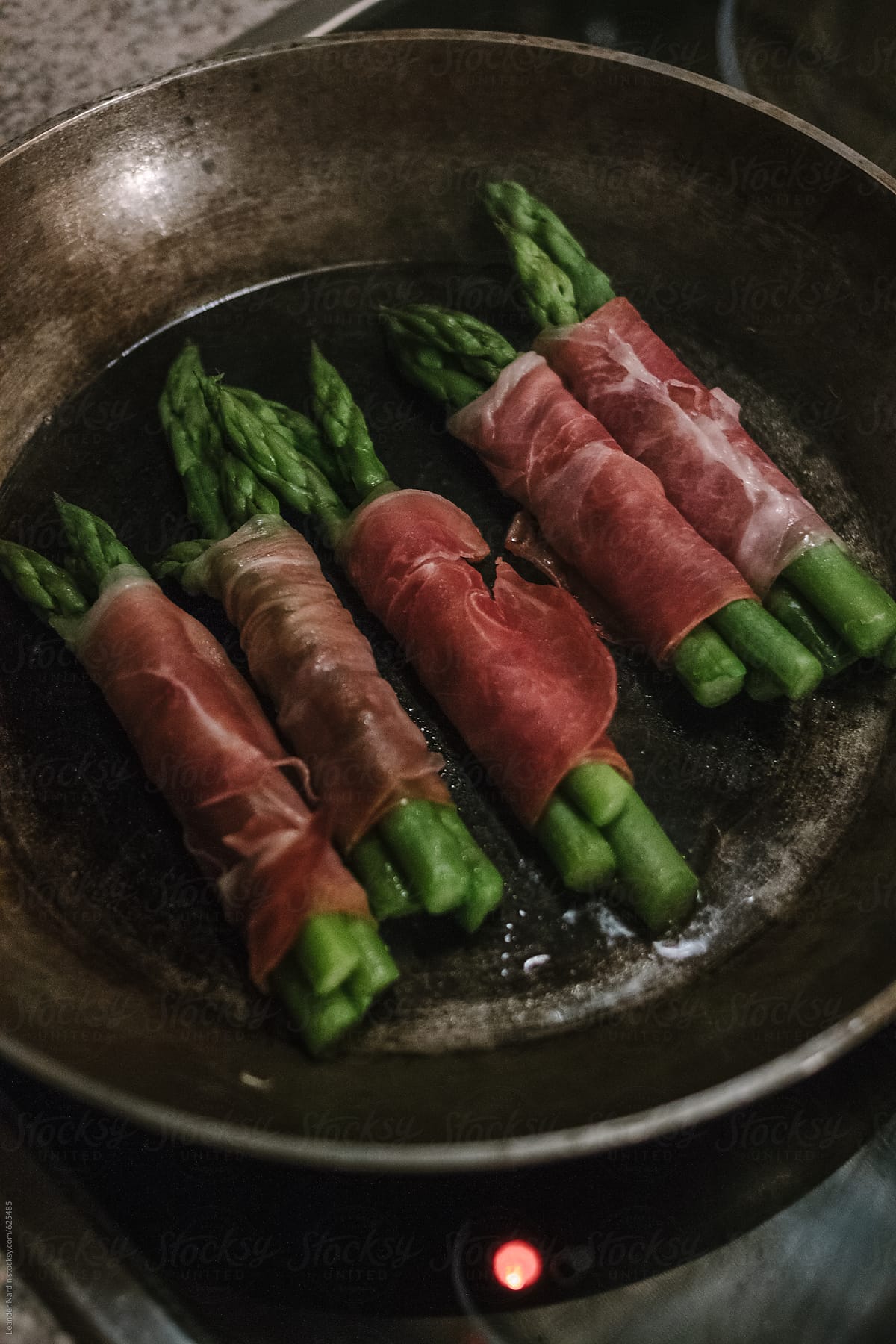 "Green Asparagus Wrapped In Prosciutto Ham Cooking In An Iron Pan" by ...