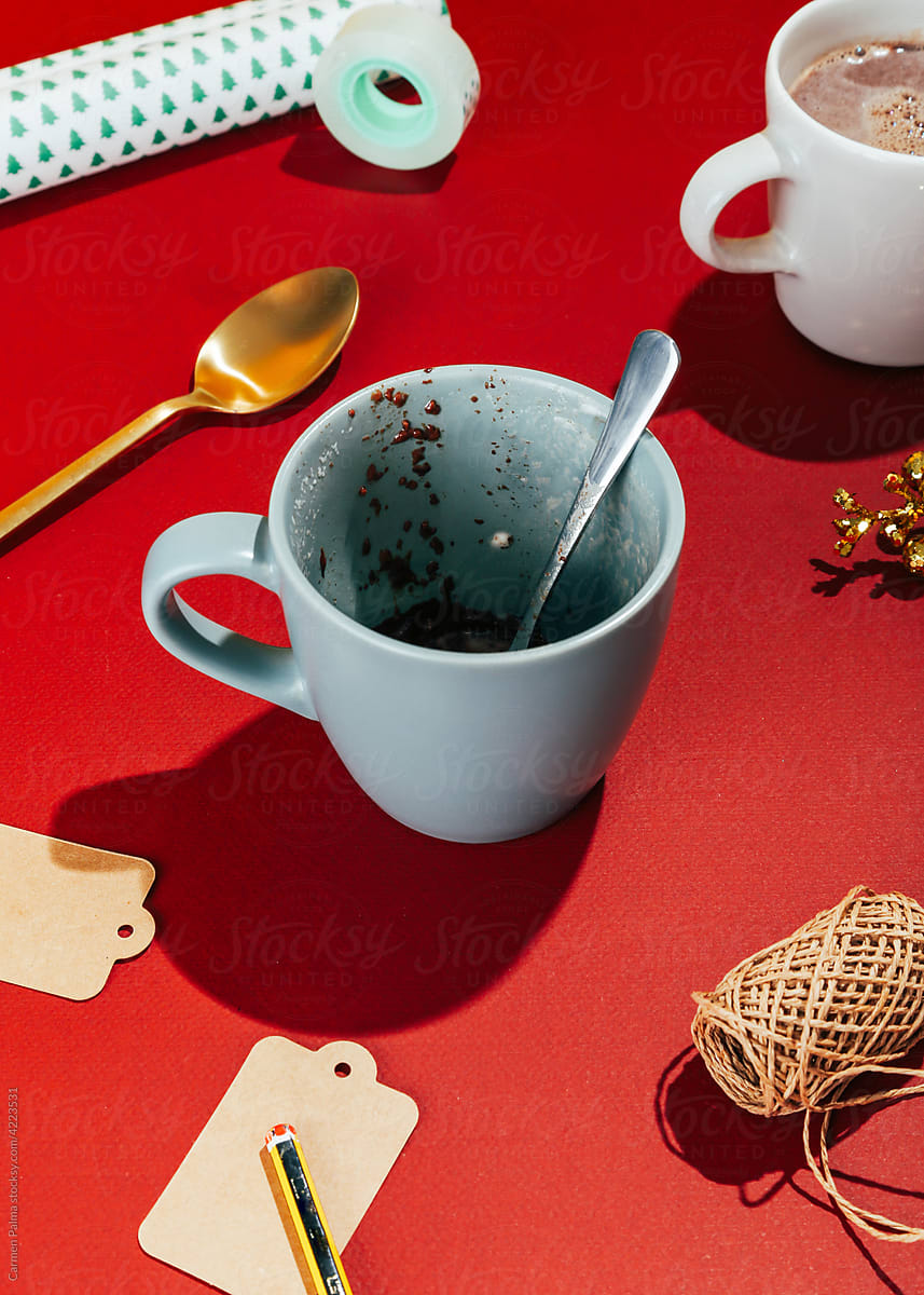"An Empty Cup Of Chocolate With Milk, Over A Red Table" by Stocksy ...