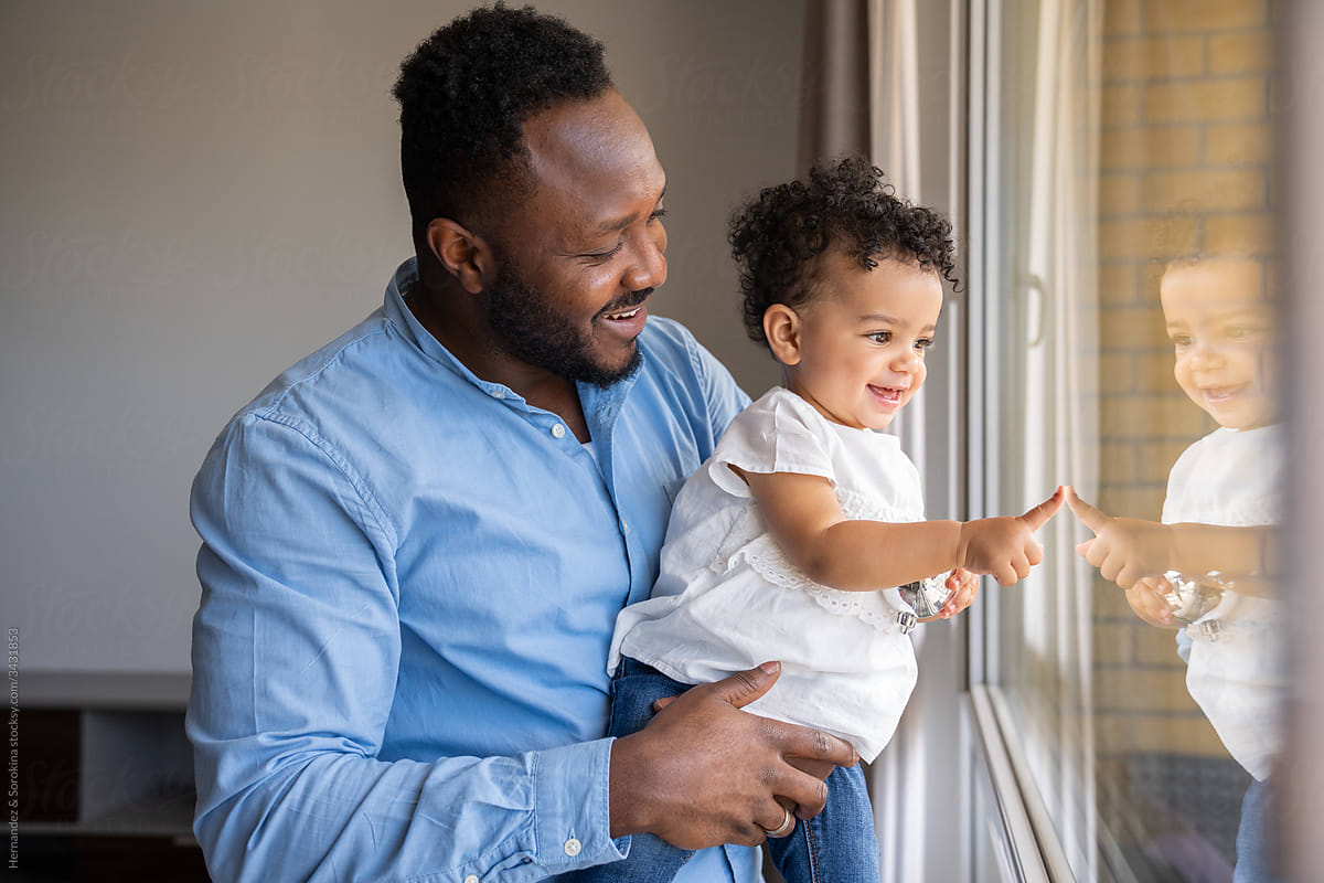"Father And Daughter Looking Through The Window" by Stocksy Contributor ...