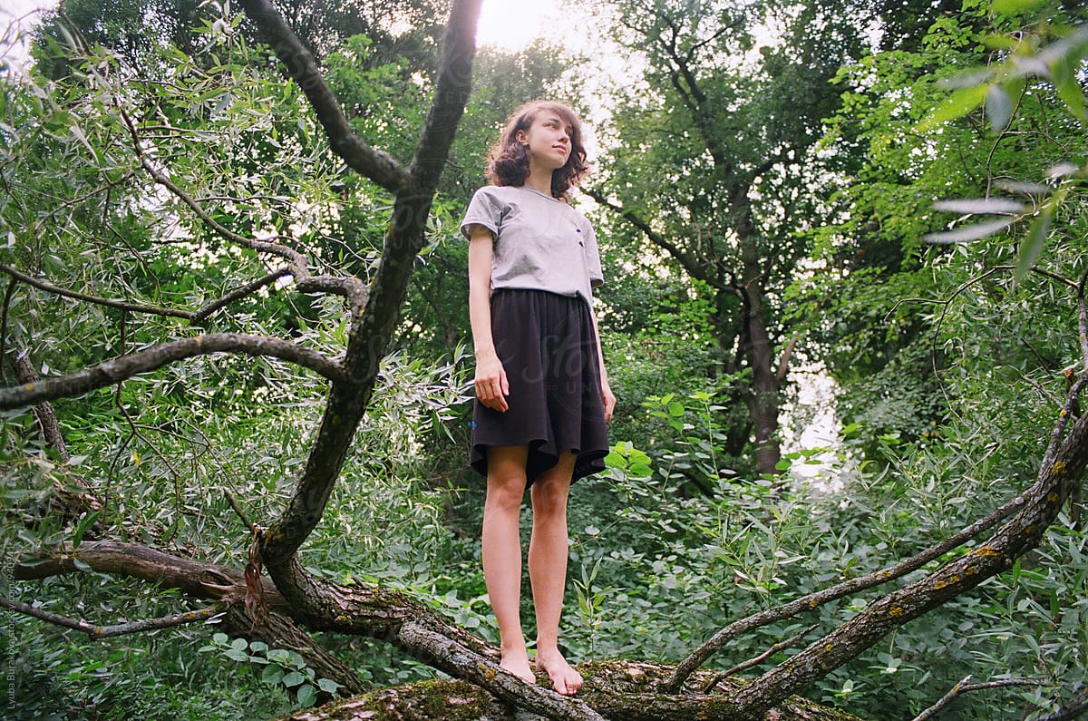 "Young Woman Standing On A Fallen Tree" by Stocksy Contributor "Amor ...