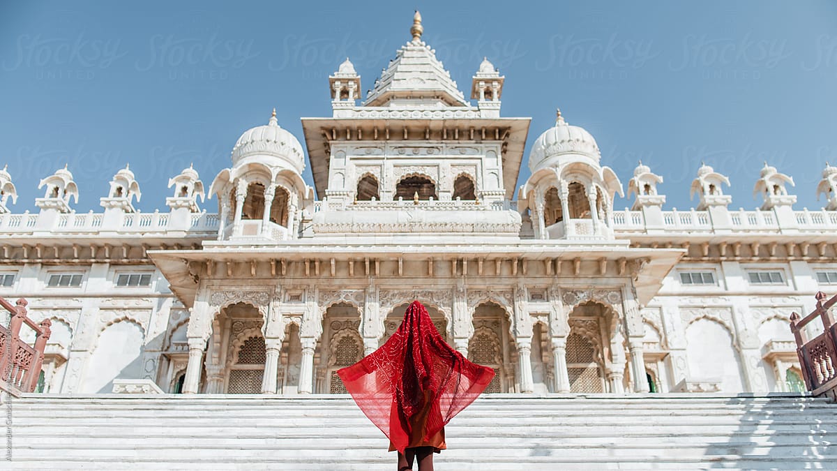 "Woman In Red Veil Facing Majestic Indian Palace" by Stocksy ...