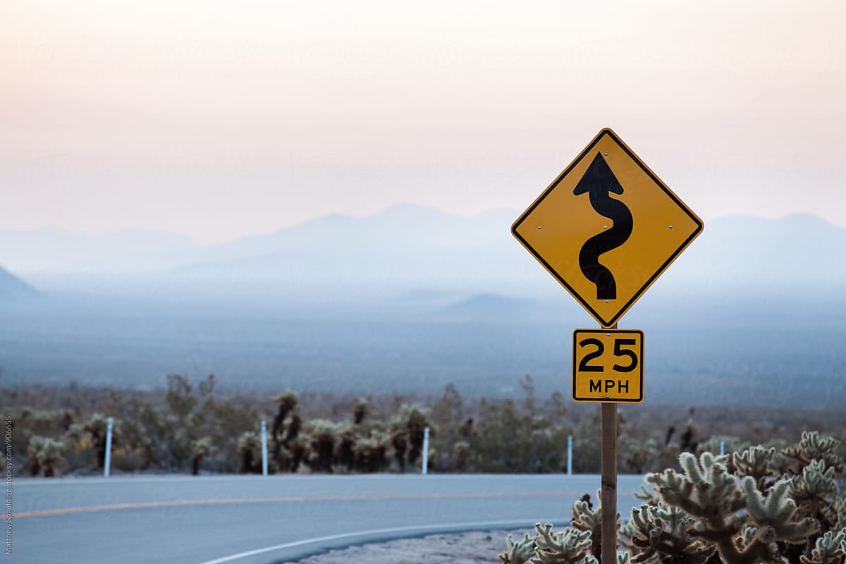 "Sign For Winding Road In Desert" by Stocksy Contributor "Matthew ...