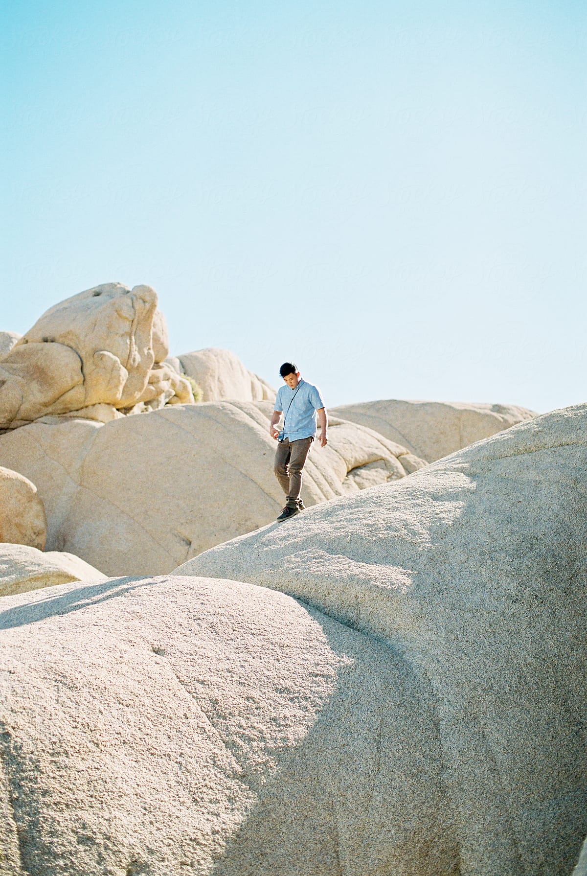 "Man Walking On Large Rock" by Stocksy Contributor "Daniel Kim ...
