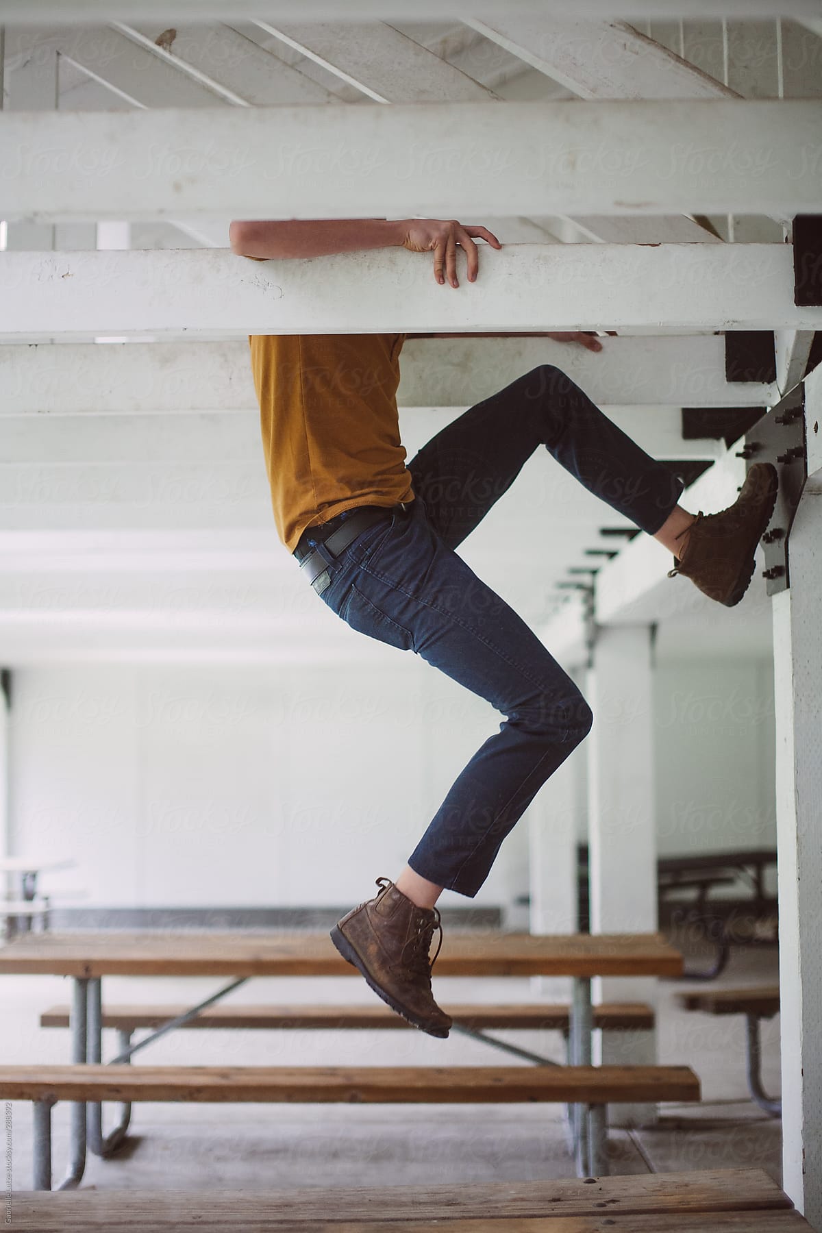 "Young Man Climbing In The Rafters Of A White Barn" by Stocksy ...