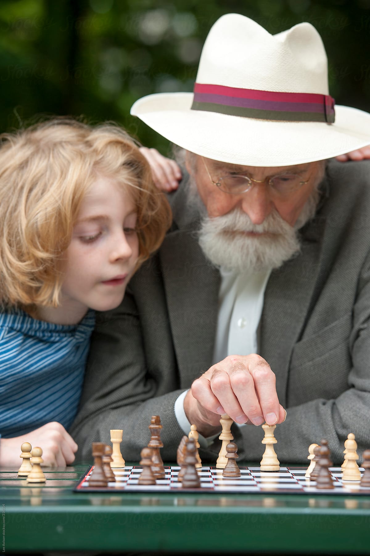 "Grandfather Playing Chess With His Grandchildren" by Stocksy ...