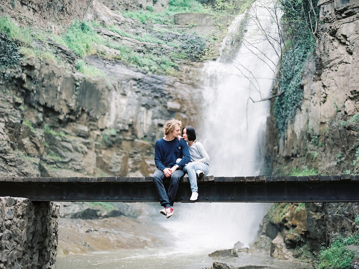 "A Couple Sitting near Waterfall" by Stocksy Contributor "Alexandr ...