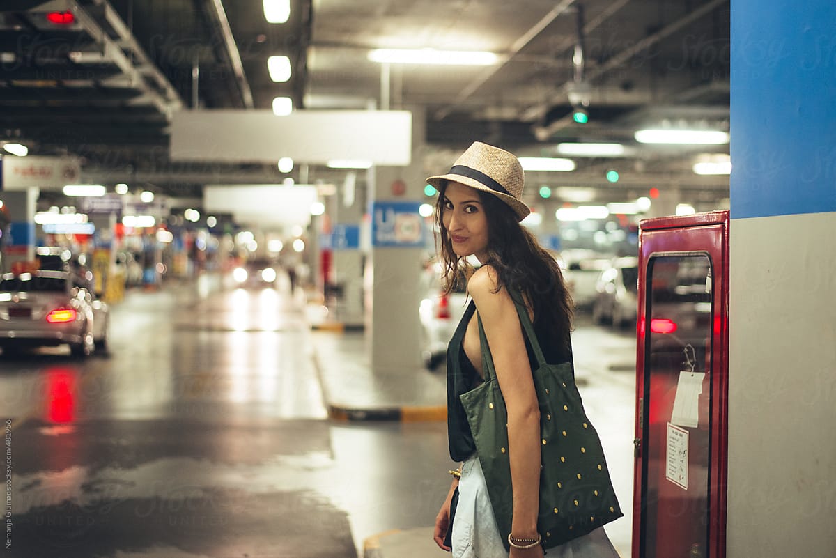 "Carefree Young Woman Walking In A Huge Concrete Garage" by Stocksy ...