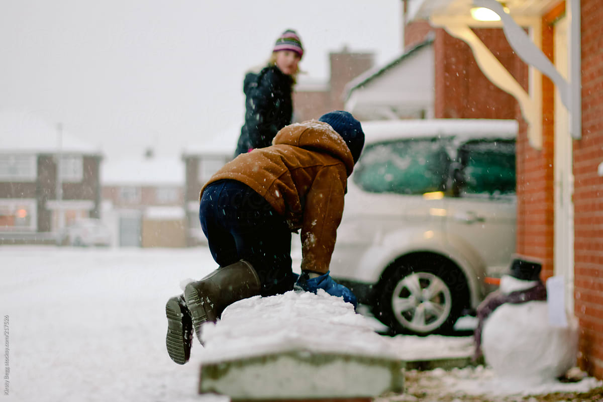 "Children Playing In The Snow At Home" by Stocksy Contributor "Kirsty ...