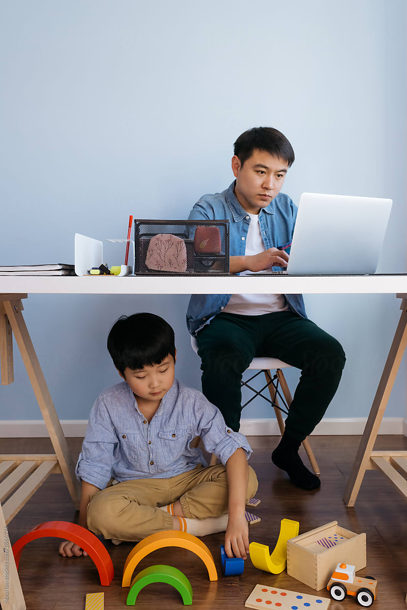 "Father Working At Home" by Stocksy Contributor "MaaHoo" - Stocksy