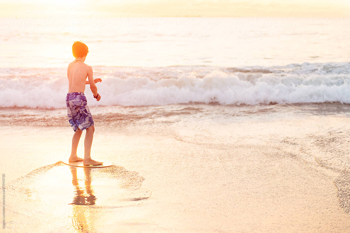 "Riding A Skim Board At The Beach At Sunset" by Stocksy Contributor ...