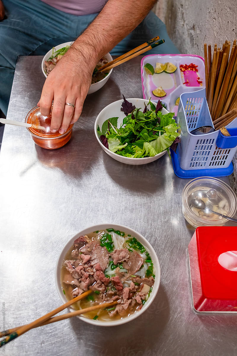 "Hand Picking Up Chili Sauce At A Vietnamese Eatery" by Stocksy ...