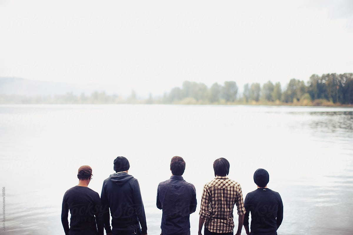 "Men Look Out On River" by Stocksy Contributor "Kevin Russ" - Stocksy