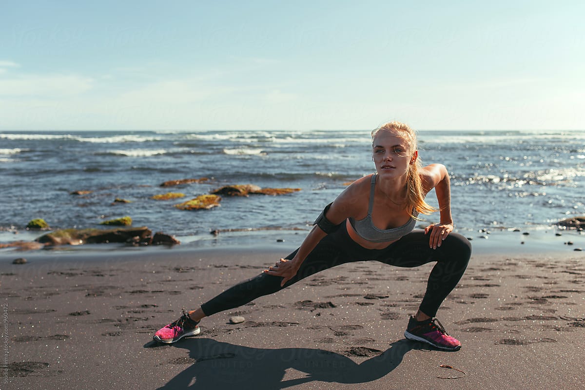 "Stretching On The Beach" by Stocksy Contributor "Studio Firma" - Stocksy