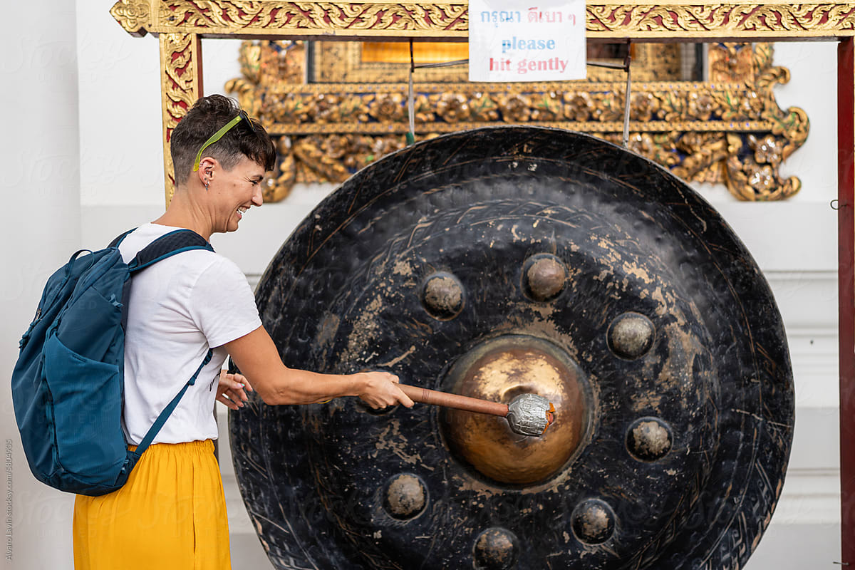 "Woman Hitting A Gong At Buddhist Temple." by Stocksy Contributor ...