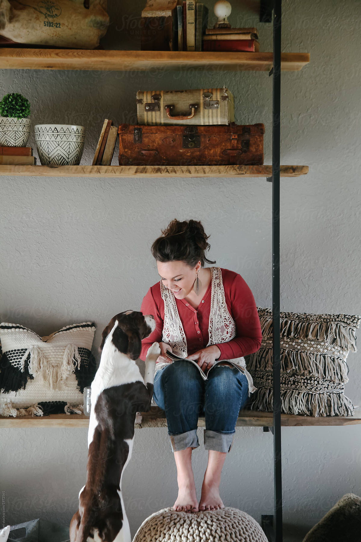 "Woman Sitting On Shelf Bench Gives Attention To Her Dog" by Stocksy ...