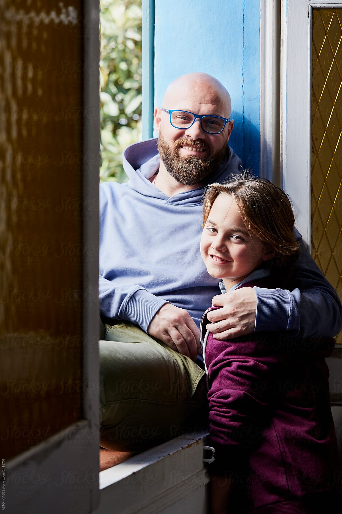 "Portrait Of Happy Man With Arm Around Son At Home" by Stocksy ...