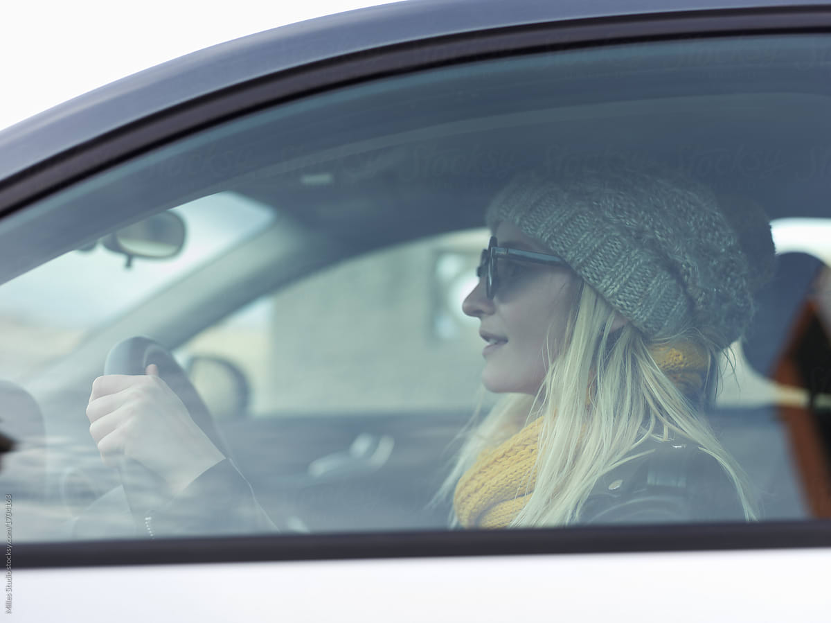 "Pretty Woman Driving Car" by Stocksy Contributor "Milles Team" - Stocksy