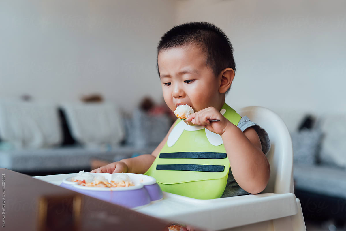 "Adorable Boy Eating At Home" by Stocksy Contributor "MaaHoo" - Stocksy