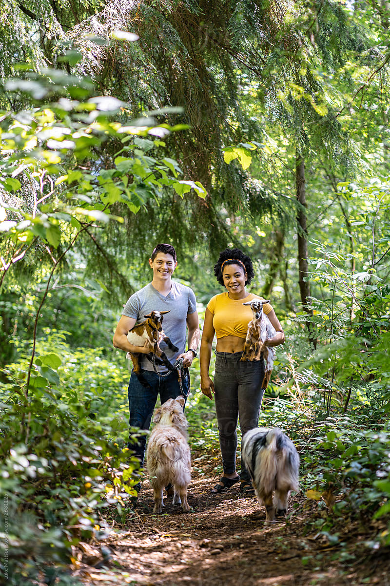 Young Married Couple With Pet Goats and Dogs - Stock Image - Everypixel