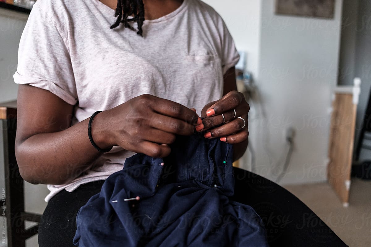 "Women Pinning Fabric" by Stocksy Contributor "Eddie Pearson" - Stocksy