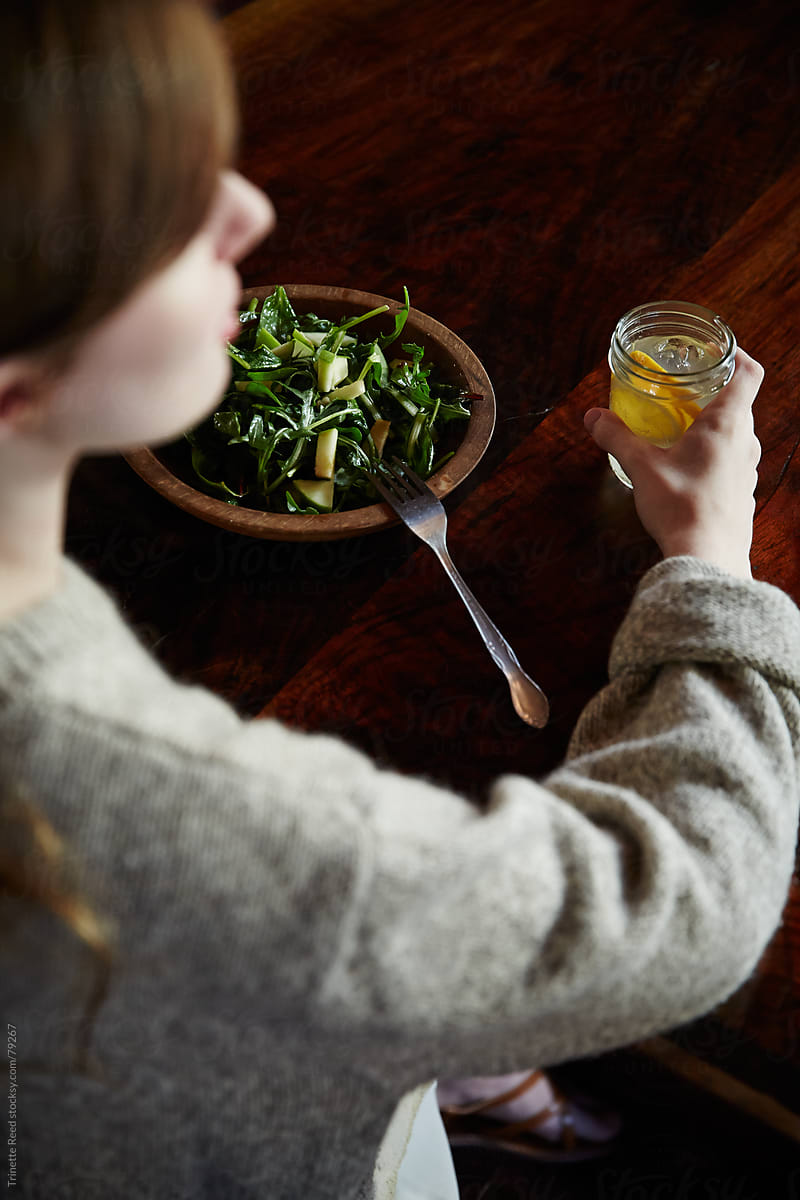 "Woman Eating Dinner At Wood Table" by Stocksy Contributor "Trinette ...