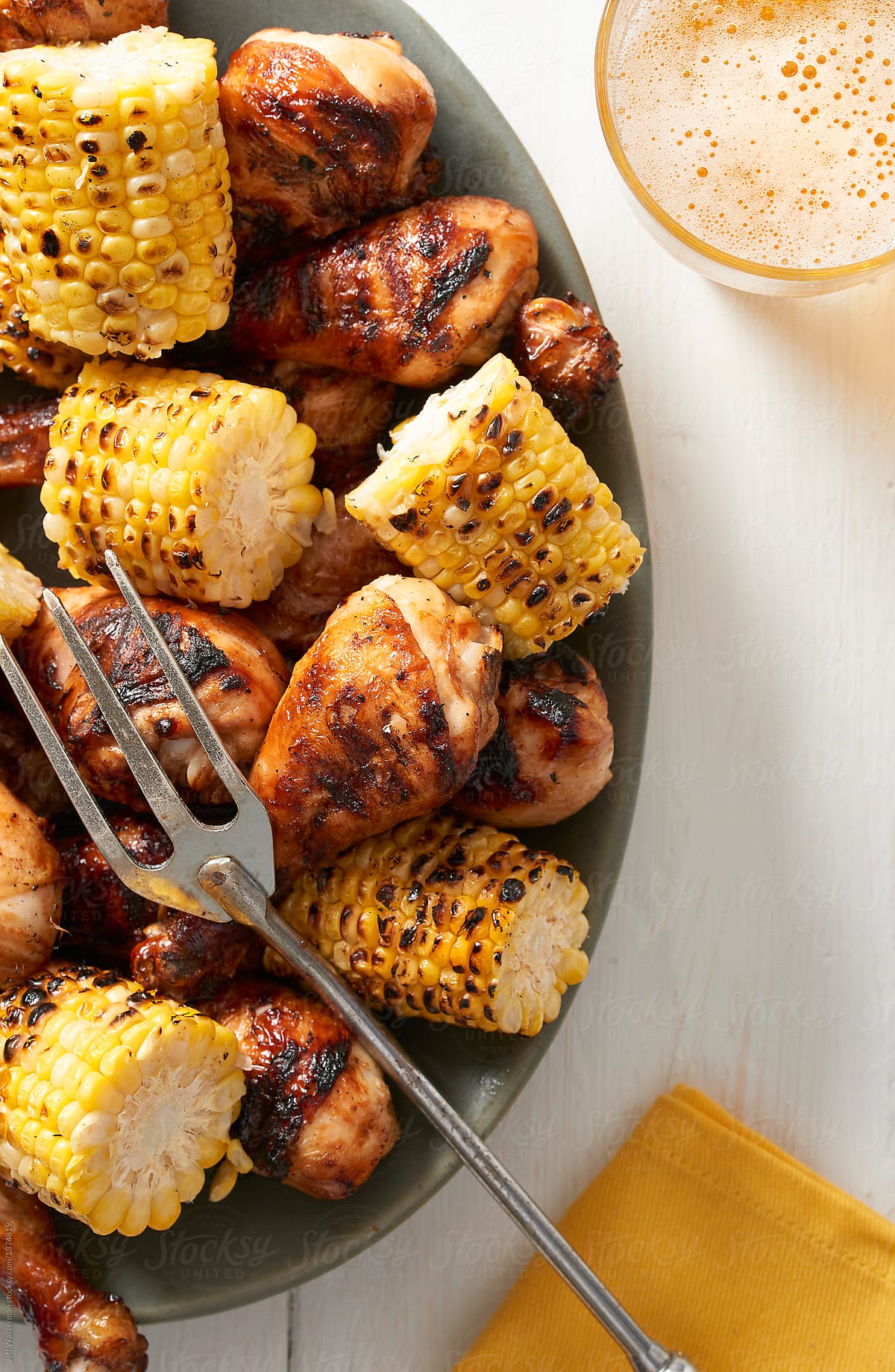 "Grilled Mexian Chicken Legs And Corn On The Cob" by Stocksy ...
