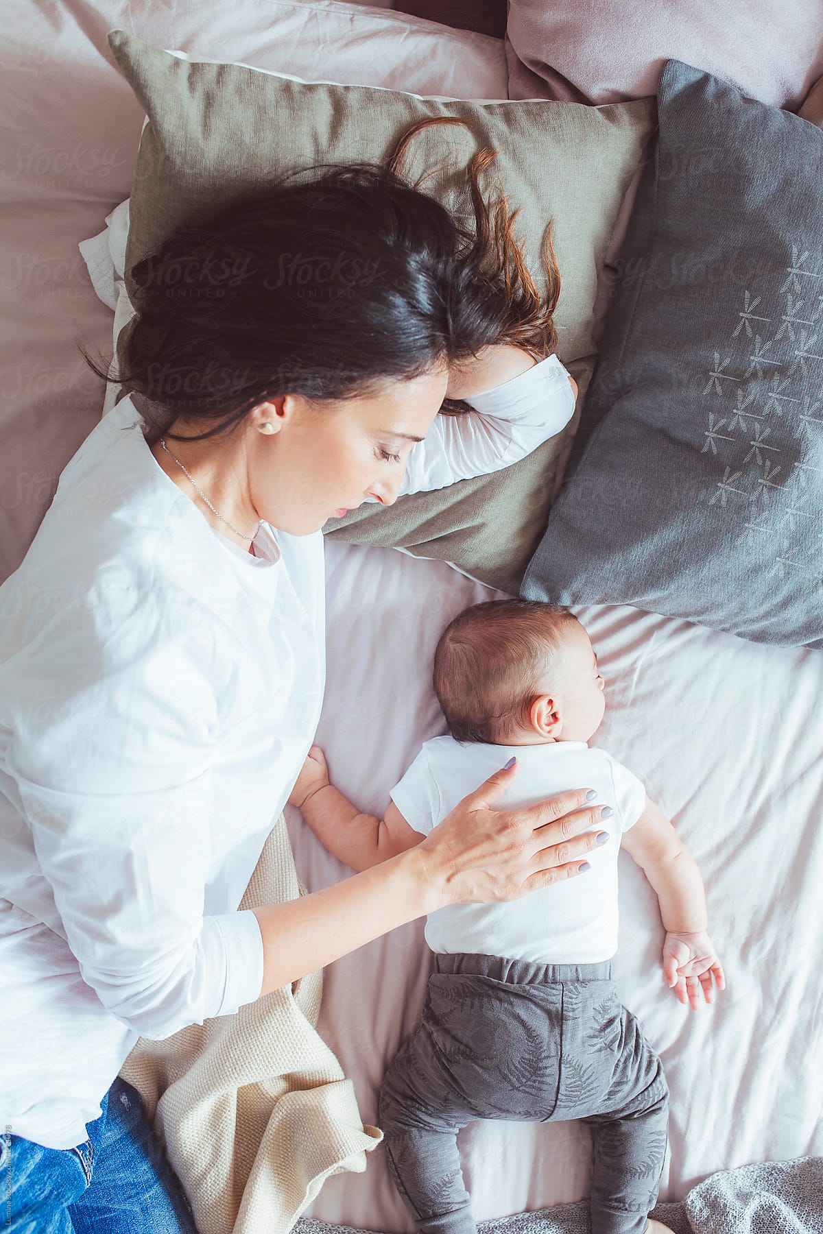 "Mother Cuddling Her Baby" by Stocksy Contributor "Lumina" - Stocksy