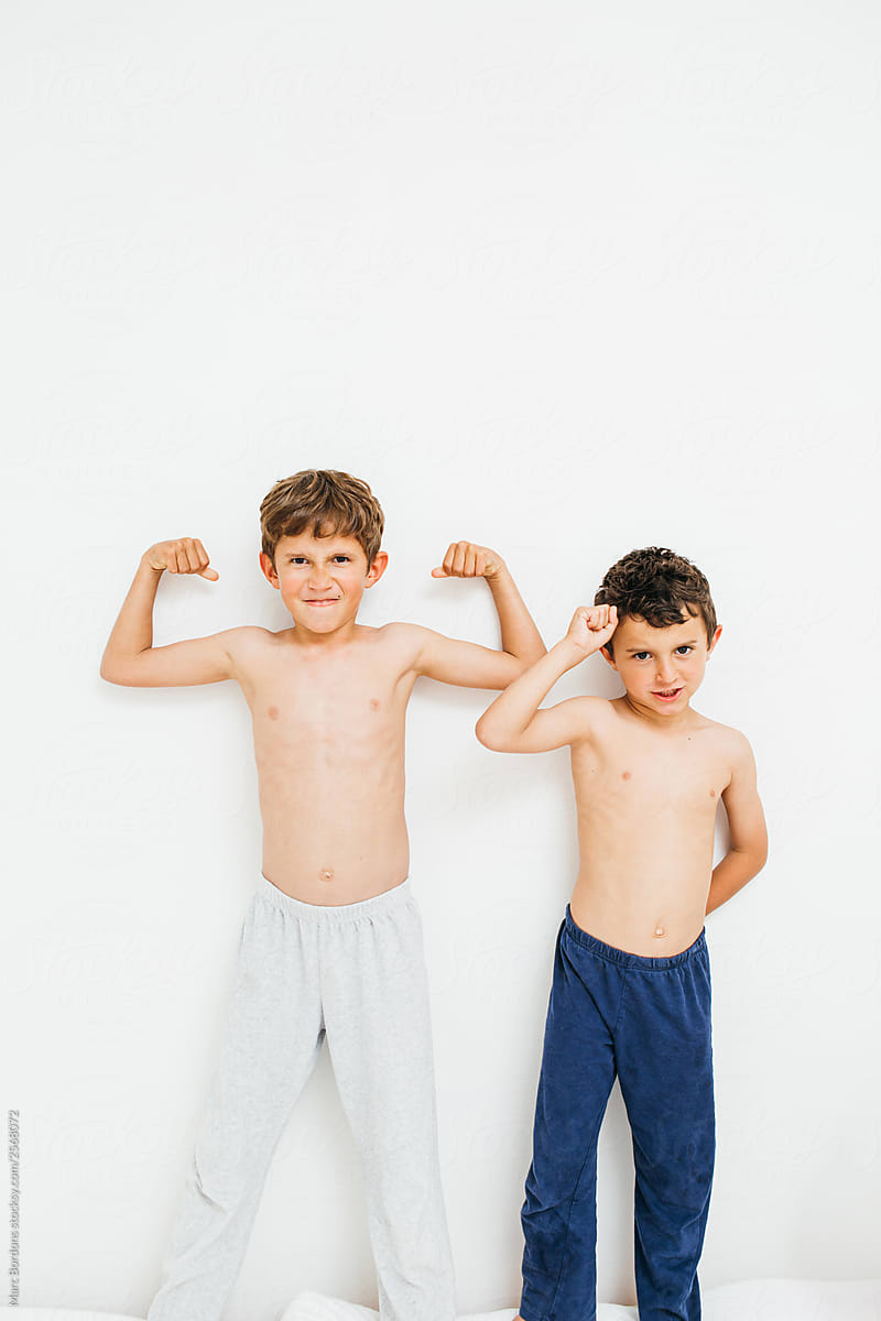 "Two Brothers Showing Their Hand Biceps Muscles." by Stocksy ...