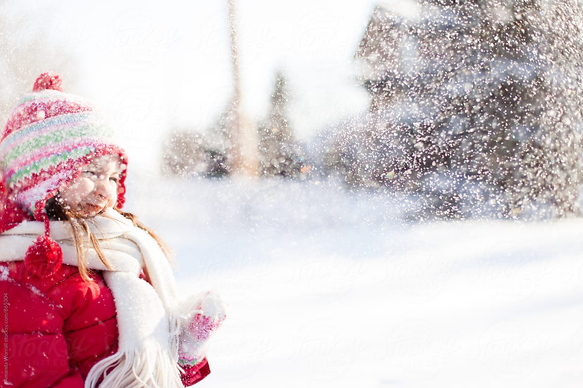 "Happy Young Girl Smiles As Snow Falls Down On Her" by Stocksy ...